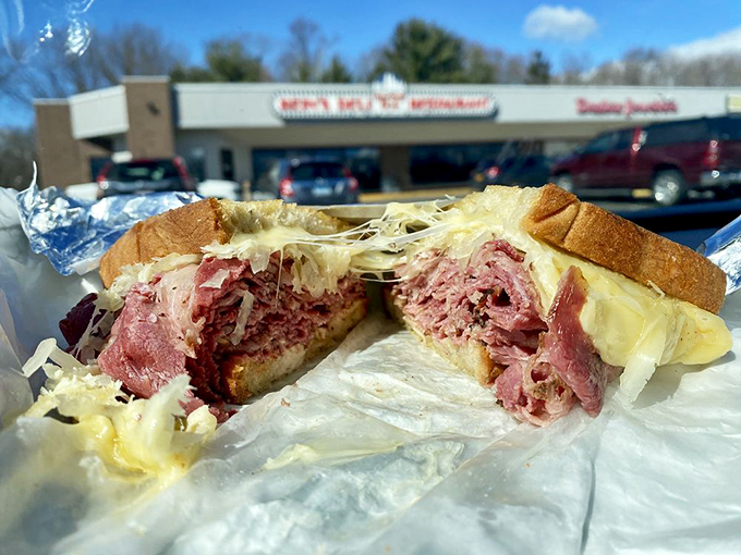 This isn't just a sandwich&mdash;it's a skyscraper of corned beef and melted Swiss that requires both hands, several napkins, and zero shame.