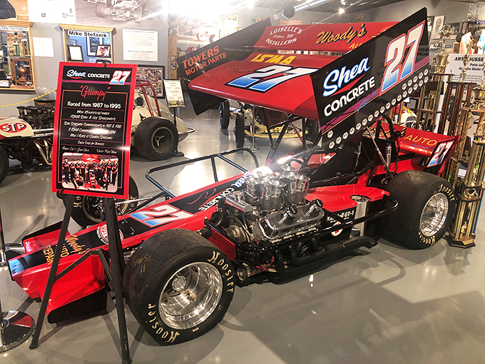 Red #27 sprint car sits poised for action, its exposed engine a mechanical work of art that once thundered around New England's dirt tracks.