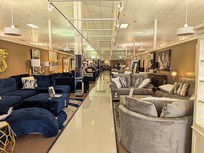 A sofa showroom that feels like speed-dating for your living room. Navy blue velvet flirts with gray textiles across the polished runway.