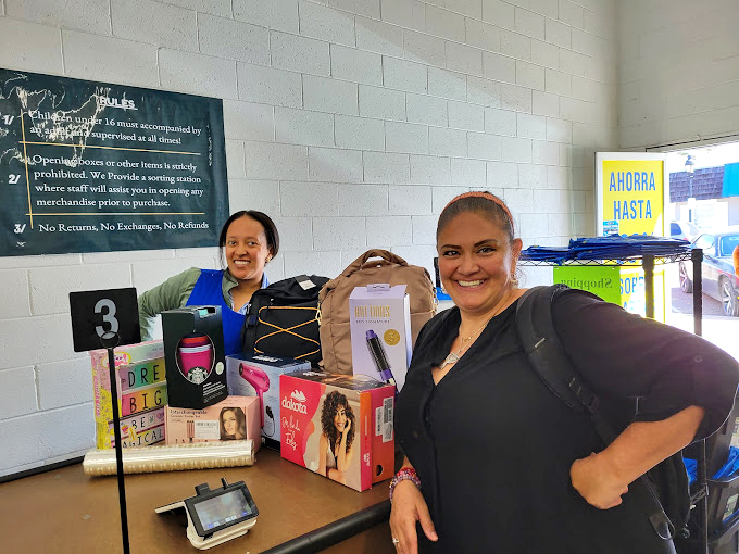 The real magic of bin stores: connections made over shared discoveries. Their expressions capture the pure joy of retail serendipity.