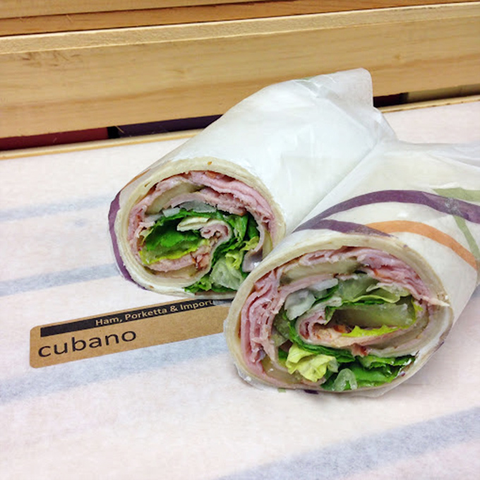 The Cubano wrap&mdash;where ham, porketta, and greens unite in a handheld masterpiece that makes desk lunches feel like a Mediterranean vacation.
