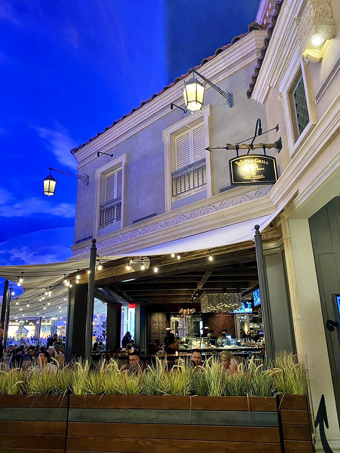 Water Grill's elegant exterior lights up as evening falls, promising a seafood experience that's as sophisticated as it is satisfying.