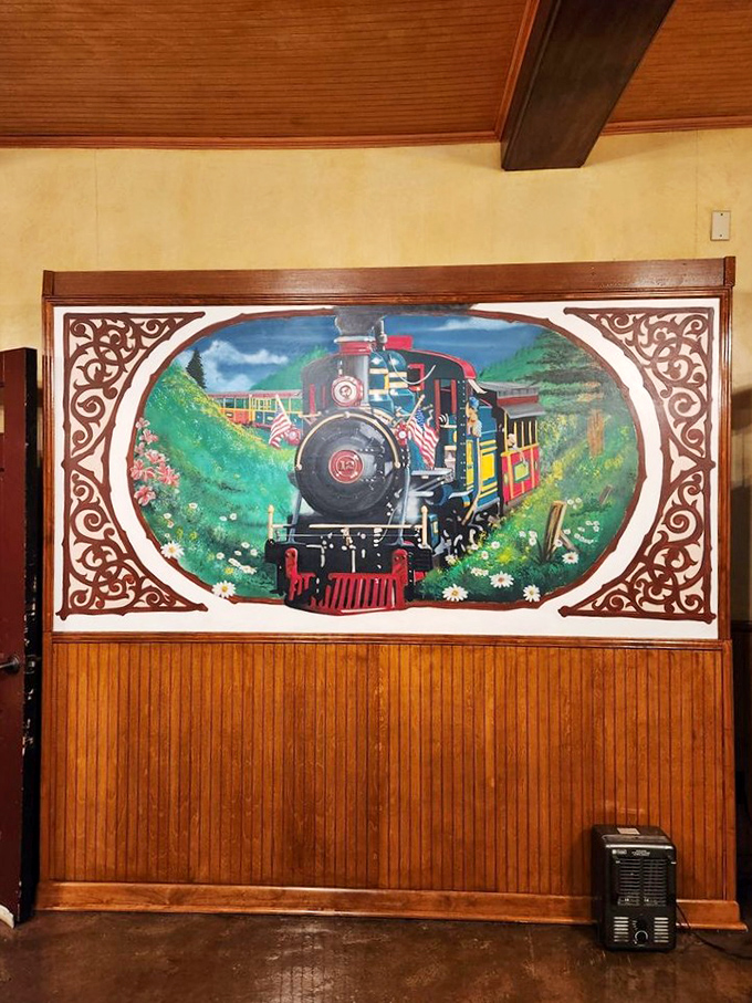 The hand-painted mural captures both the romance and reality of steam locomotion, ensuring the train's legacy continues between the actual rides.
