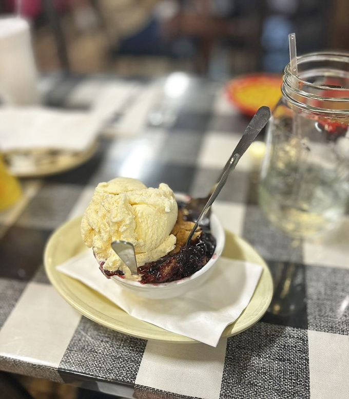 Berry cobbler à la mode – where summer fruit and vanilla ice cream engage in the dessert equivalent of a perfect slow dance.