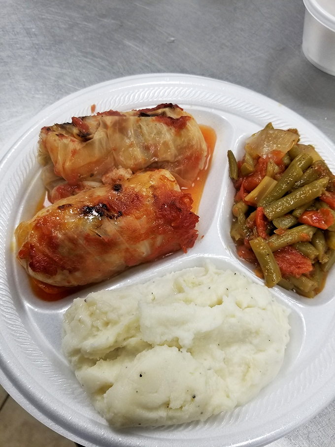 Cabbage rolls that grandmothers everywhere would approve of, nestled alongside green beans that refuse to be ordinary.