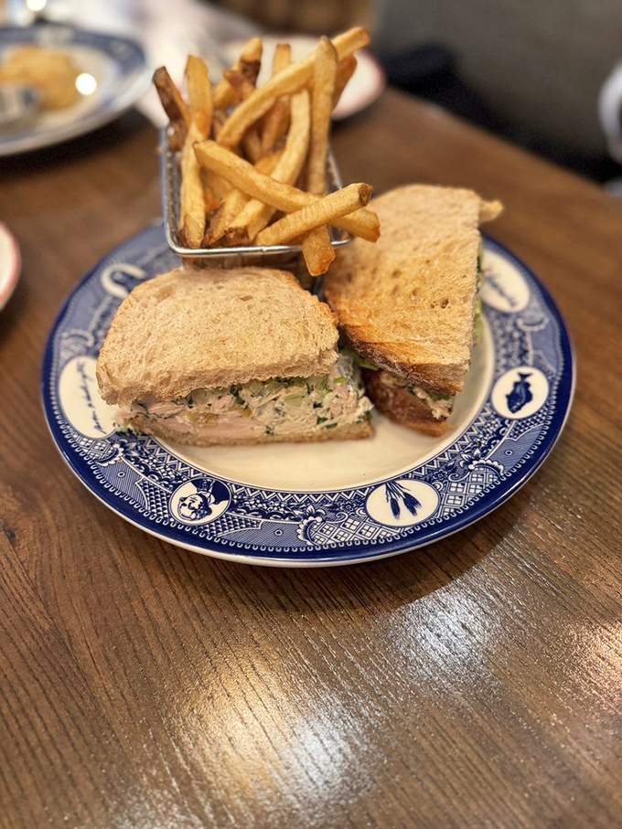 The sandwich that lunch dreams are made of. Hearty chicken salad between slices of wholesome bread, with a side of fries that look hand-cut and perfectly golden.