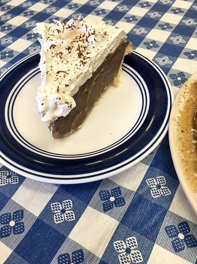 Chocolate cream pie topped with cloud-like whipped cream—proof that heaven might actually be located somewhere in Arkansas.