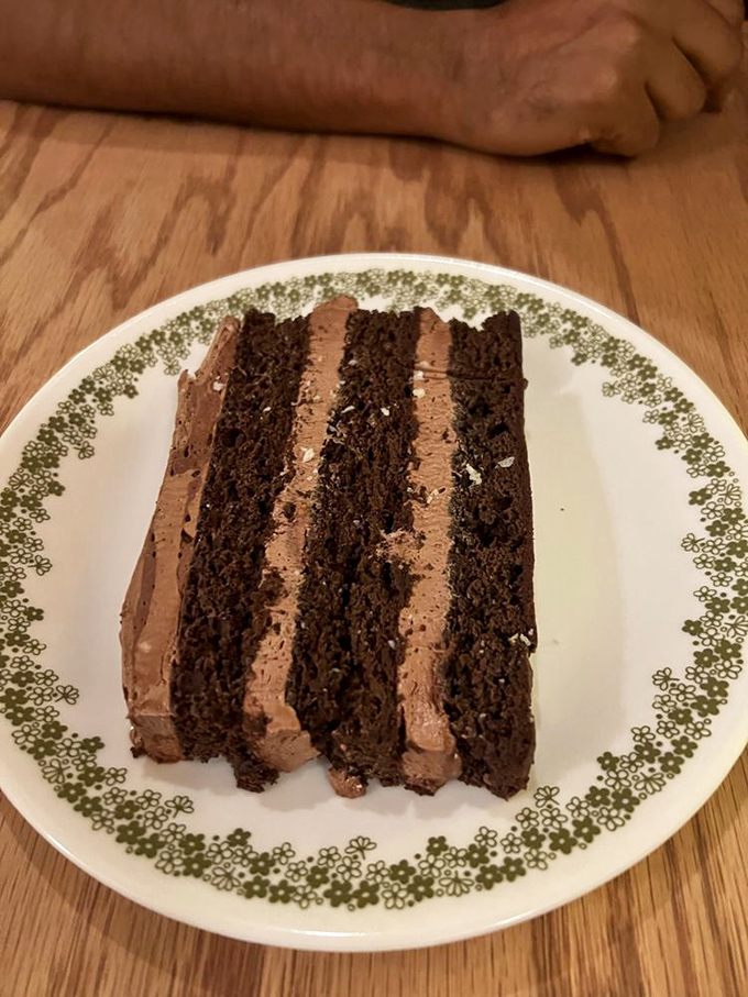 Chocolate cake layered with such precision it could teach geometry. Each forkful delivers the kind of richness that makes you forget your manners.