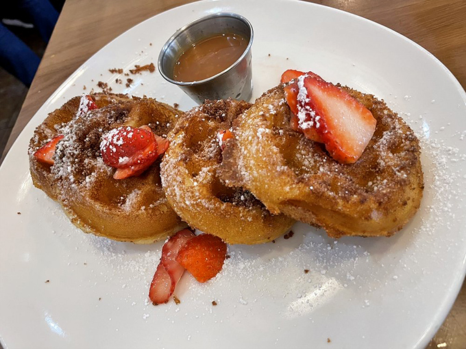 Churro waffles that make you question why all waffles aren't coated in cinnamon sugar and paired with fresh strawberries.
