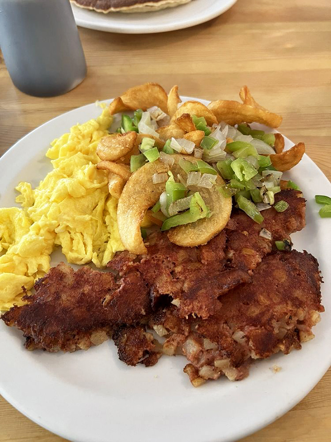 Corned beef hash with that perfect crispy-to-tender ratio, scrambled eggs, and grits &ndash; a breakfast triple threat that demands a nap afterward.