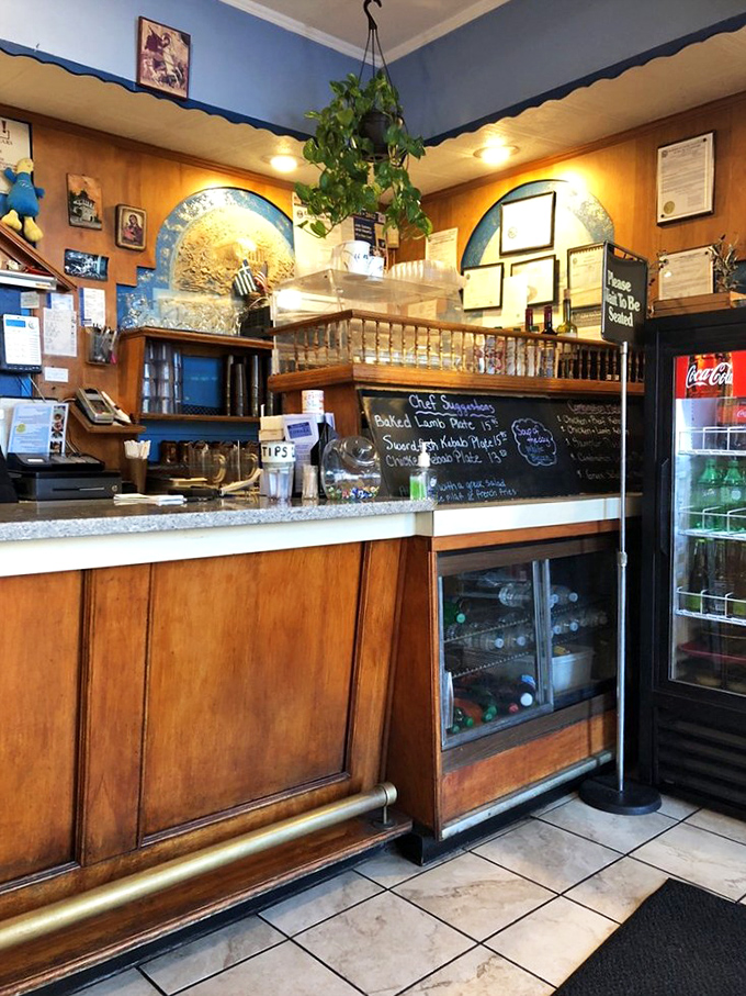 The counter where dreams come true. Behind that wooden fa&ccedil;ade lies the kitchen where Mediterranean magic happens daily.