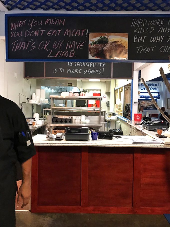 Behind this counter, culinary magic happens daily. The chalkboard humor suggests they season their food with both spices and wit.