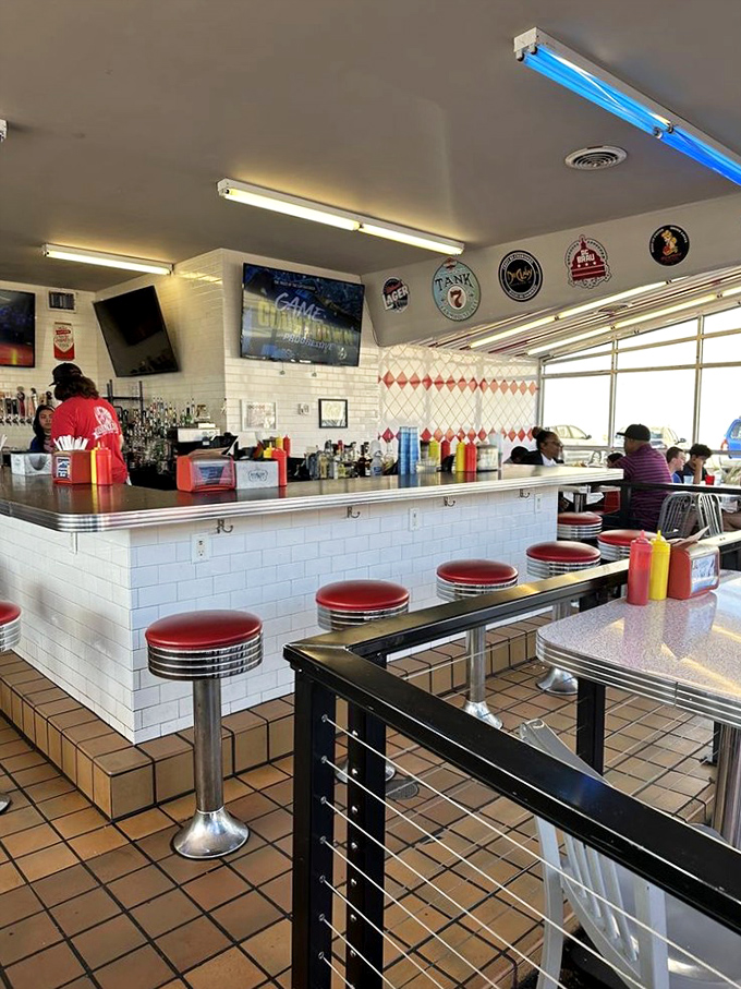 The counter where burger dreams come true. Those red stools aren't just seating&mdash;they're front-row tickets to the best show in Richmond.