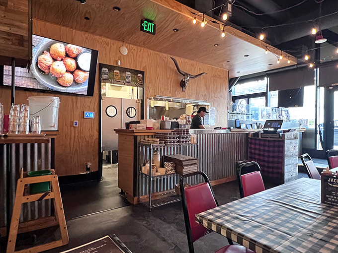The dining area's rustic-industrial vibe with string lights creates the perfect backdrop for the serious business of barbecue appreciation. 