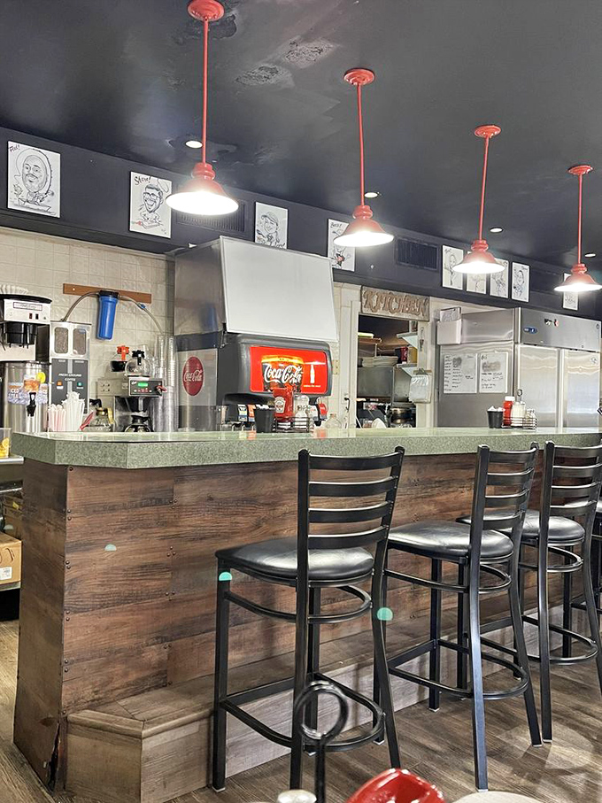 The open kitchen and counter seating let you watch the magic happen. Those red pendant lights aren't just for ambiance&mdash;they're keeping a watchful eye on your soon-to-be-devoured breakfast.
