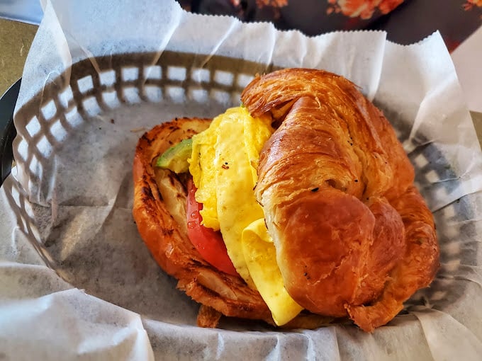 Breakfast sandwich architecture at its finest. That croissant didn't just happen; it was engineered for maximum butter-to-filling ratio perfection.