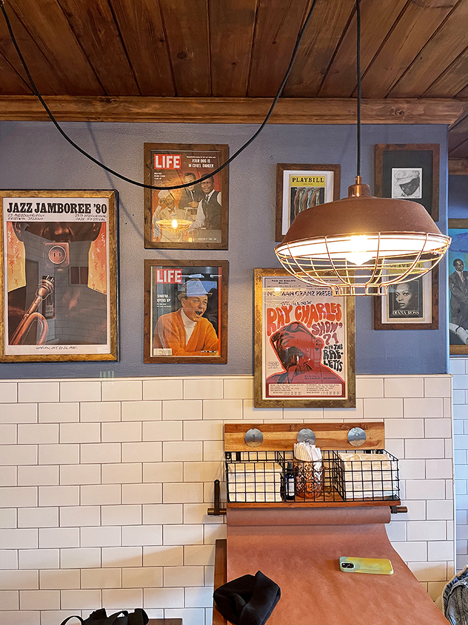 Vintage posters and industrial lighting create the perfect backdrop for serious burger contemplation and inevitable food euphoria.
