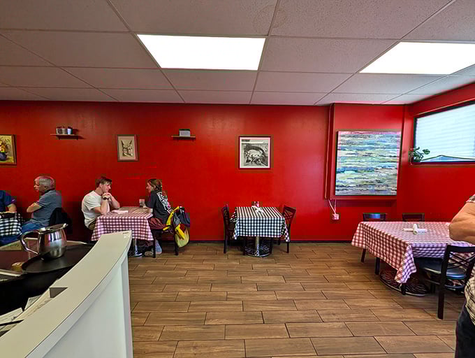 Red walls that embrace you like a warm hug, creating the perfect backdrop for the Italian feast about to unfold.