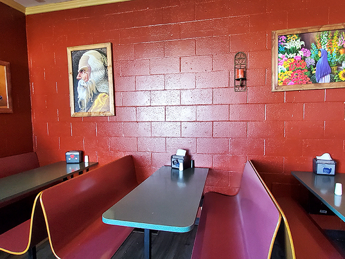 Red walls adorned with vibrant artwork create the perfect backdrop for intense debates about whether to order one more round of tacos.