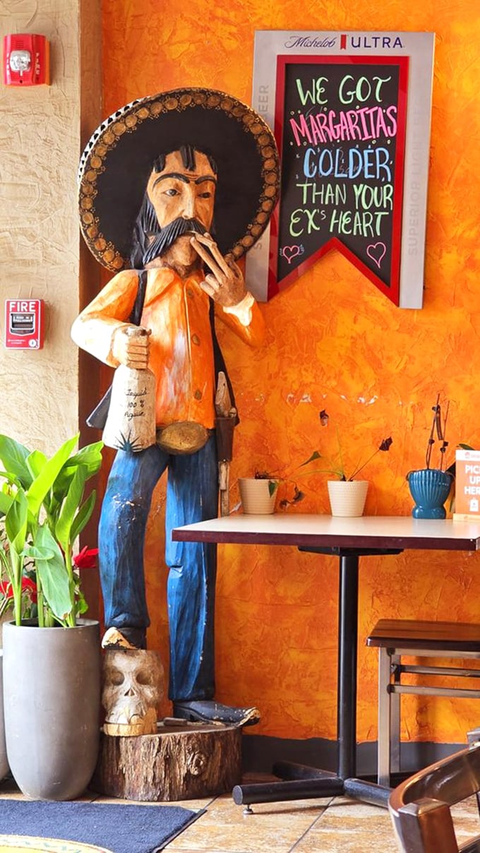 That humorous sign next to the traditional statue perfectly captures the spirit here: authentic roots with a side of New England wit.