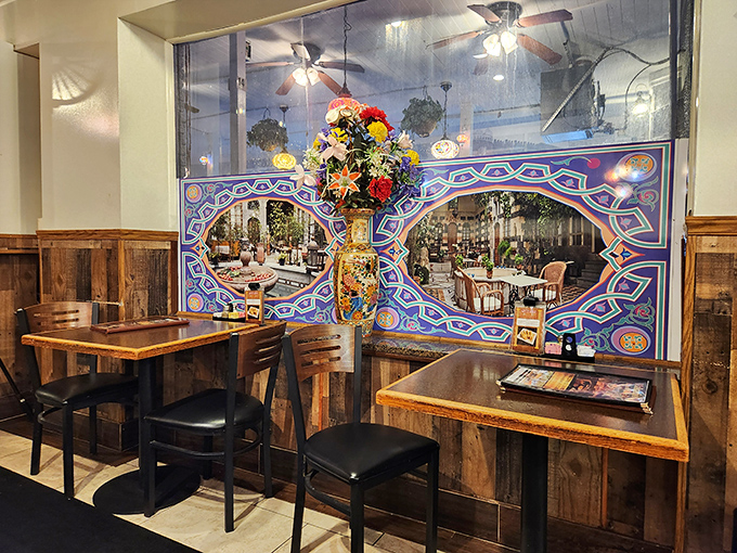 A window to another world. Rustic wood paneling and vibrant Mediterranean scenes transport diners from Birmingham to the shores of Greece.