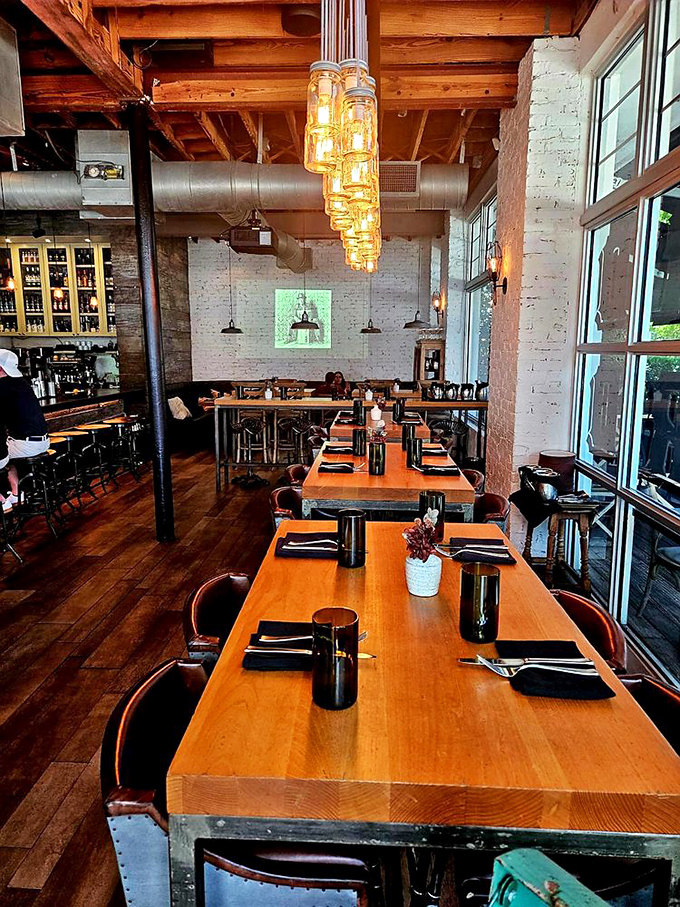 Industrial chic meets Southern hospitality. Those mason jar chandeliers aren't just lighting—they're conversation starters hanging from history-rich wooden beams.