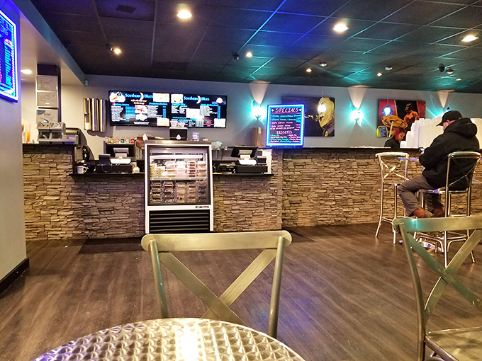 Modern meets soulful in this sleek dining space where blue lights and jazz imagery create the perfect backdrop for serious eating.