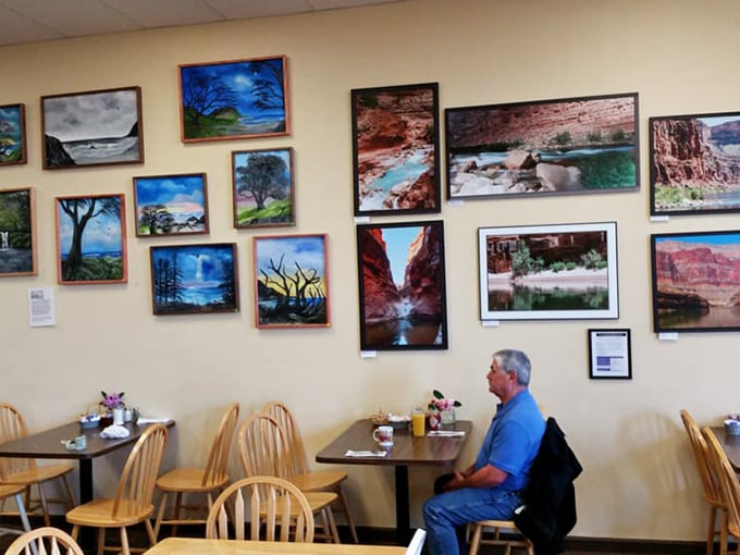 Local artwork adorns walls that have witnessed countless morning conversations. These landscapes remind you where you are while you fuel up for adventure.