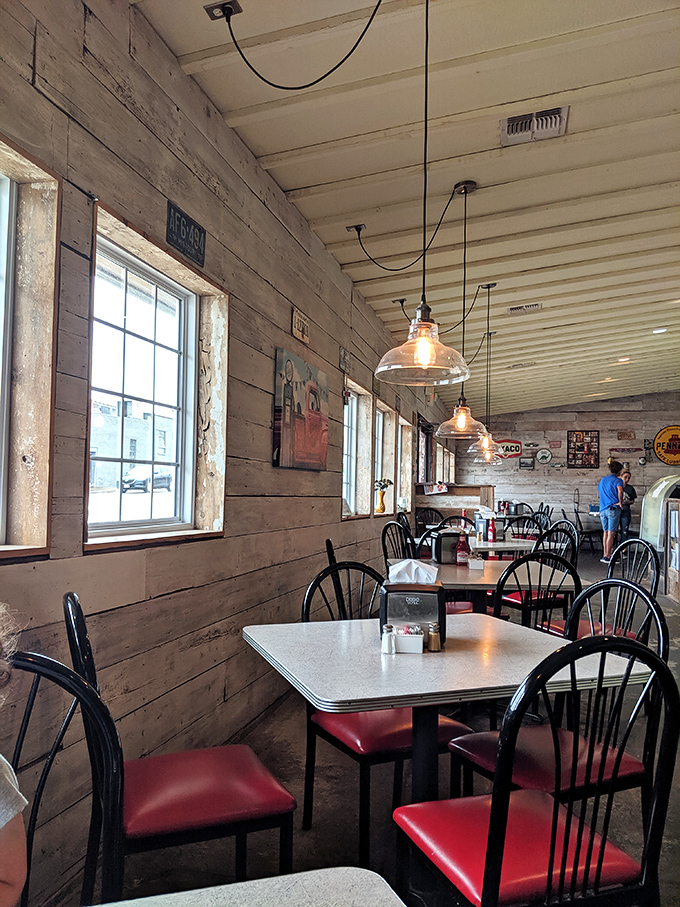 Natural light streams through windows framed by whitewashed wood planks, creating a dining space that feels both timeless and genuinely welcoming.