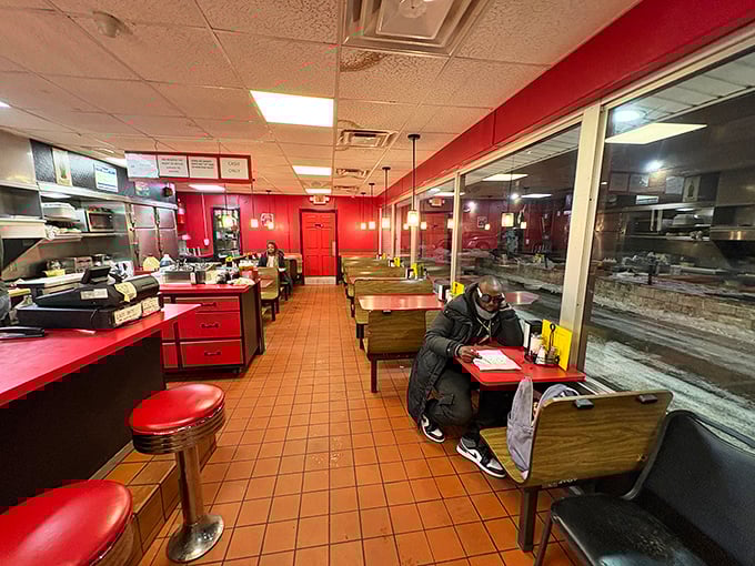 The dining area's red and wood tones create that perfect diner atmosphere where strangers become friends over coffee and hash brown philosophizing.