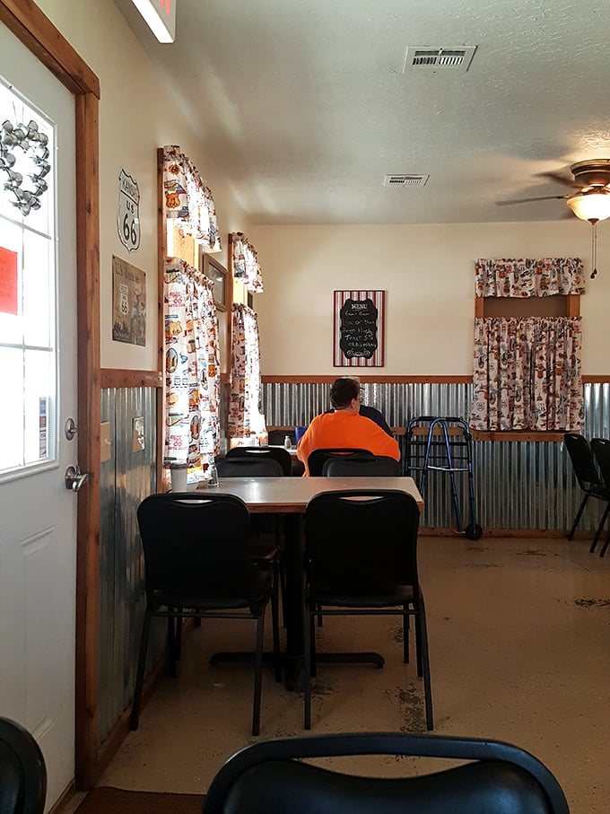 The dining room where conversations matter more than Instagram opportunities. That lone diner isn't just eating&mdash;he's participating in an American tradition.