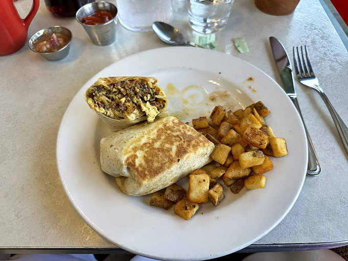 Breakfast burrito or edible art? With those perfectly golden edges and home fries standing guard, it's definitely both.
