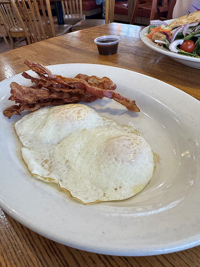 Sunny-side up eggs with perfectly crisped bacon&mdash;breakfast in its purest form. The kind of plate that reminds you why morning meals deserve our respect.