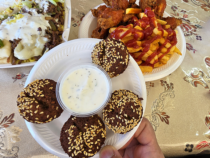 Falafel—where chickpeas go to fulfill their destiny. These golden-brown beauties with sesame seeds are crunchy on the outside, fluffy within.