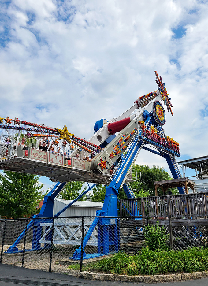 The Falling Star ride catapults brave souls skyward while onlookers decide whether they're impressed by the engineering or the riders' courage to trust it.