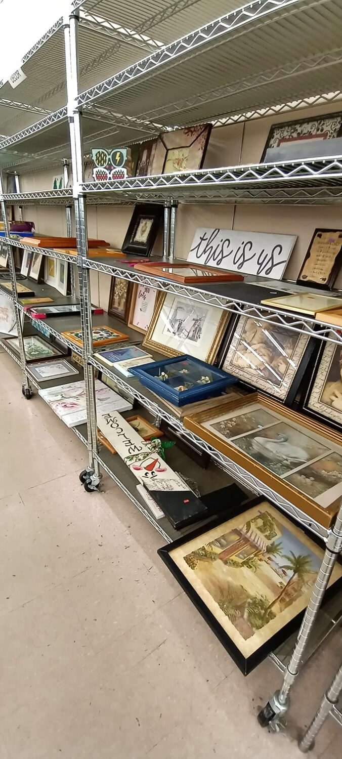 Wall art paradise where someone's "Live, Laugh, Love" becomes your ironic statement piece, and vintage coastal scenes await homes where they'll be appreciated anew.