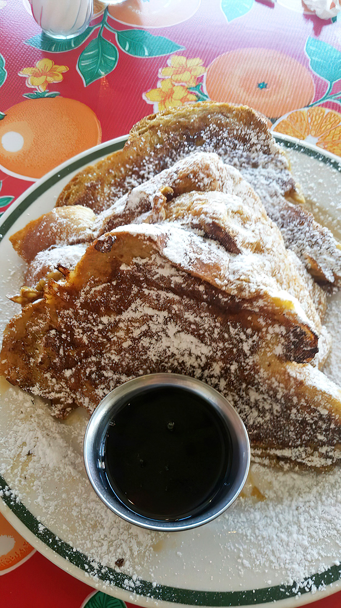 The French toast's golden exterior hides a custardy interior that makes you wonder why you ever settled for lesser versions.