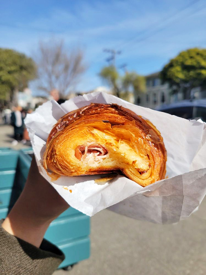 The savory rebel of the display case – ham and cheese nestled in buttery layers, proving that croissants don't always need to play sweet.