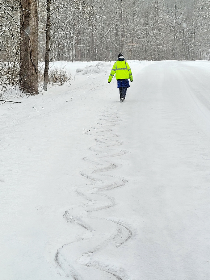 Winter transforms Big Run's trails into a snow-covered wonderland. The neon jacket says "safety first," the footprints say "adventure ahead."