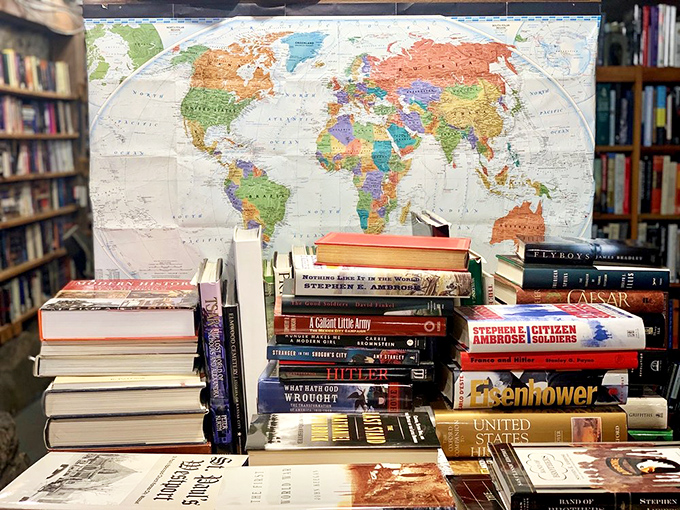 History section with a world map backdrop&mdash;because understanding where we've been helps us navigate where we're going.