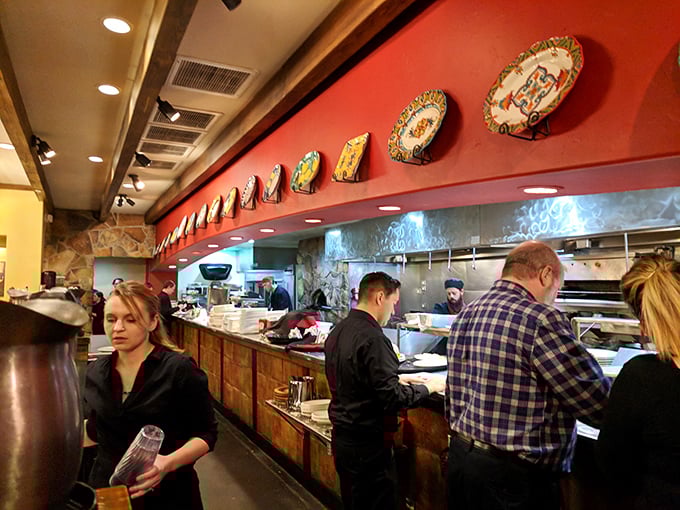 Culinary choreography in action. The kitchen staff moves with practiced precision, turning basic ingredients into plates of Italian-American magic.