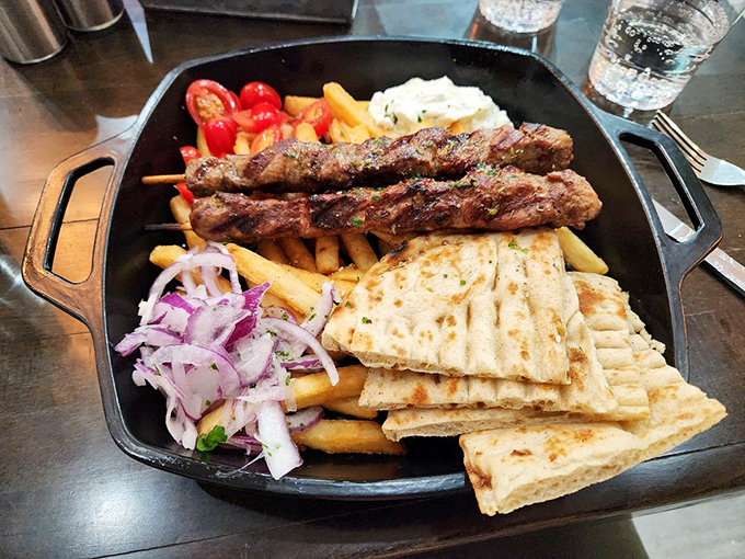 Lamb souvlaki that's been kissed by fire and served with all the fixings&mdash;proof that food on a stick is humanity's greatest culinary achievement.