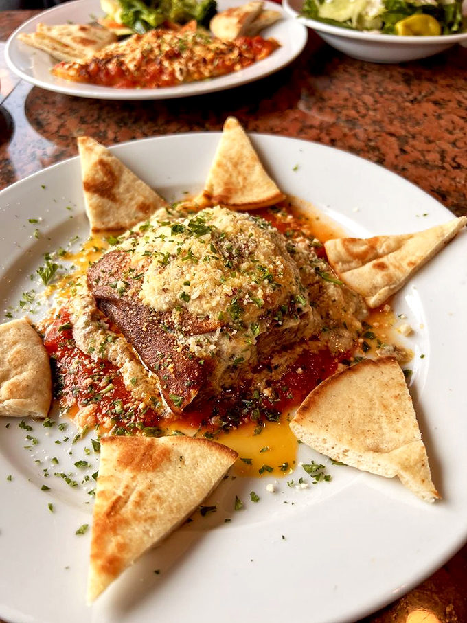 Moussaka: where layers of eggplant, meat, and b&eacute;chamel sauce come together like a Greek lasagna love story. The pita triangles add punctuation.
