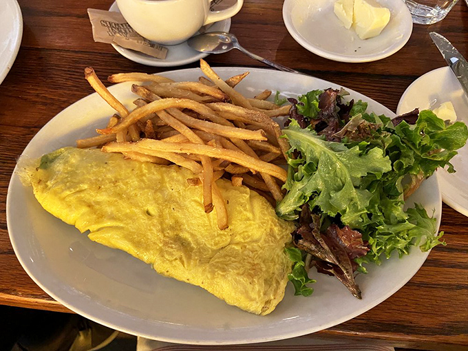 The perfect omelet—deceptively simple yet culinary Mount Everest. Buttery, golden exterior hiding whatever treasures the chef tucked inside.