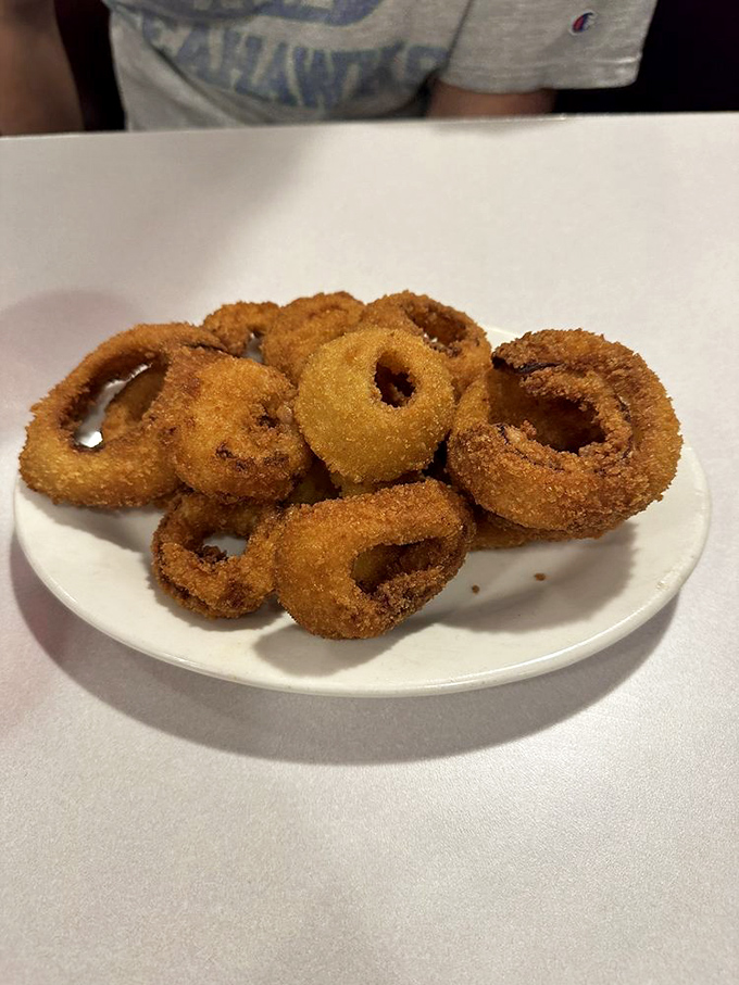 Onion rings so perfectly golden and crisp, they make that satisfying crunch sound that's music to a hungry diner's ears.