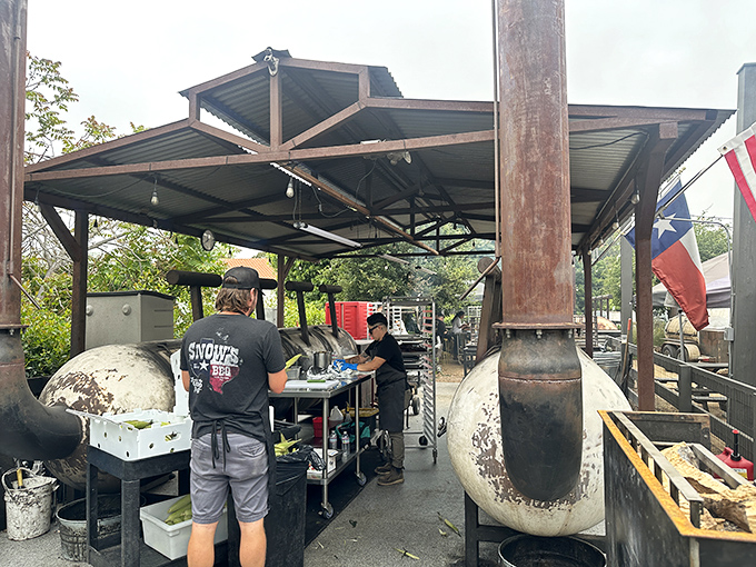 Behind the smoke curtain: Where the magic happens. These pitmasters treat fire and meat with the reverence of classical musicians approaching Mozart.