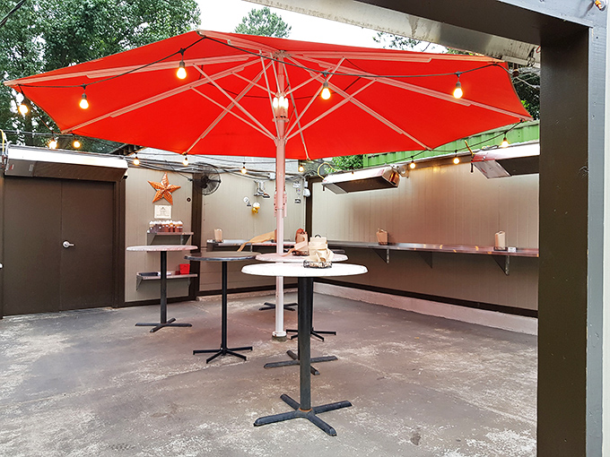 The outdoor dining area&mdash;simple, functional, and somehow perfect. Under that red umbrella, even a Tuesday lunch feels like a special occasion.
