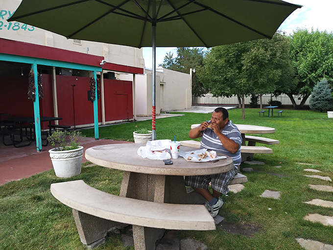 Outdoor dining at its most honest—concrete tables under New Mexico's brilliant blue sky, where the only garnish needed is fresh air.