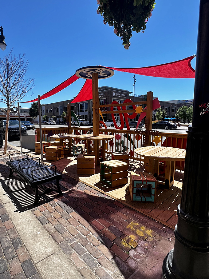 Even the outdoor seating area refuses to be ordinary. Those red canopies provide shade with a side of style for downtown diners.