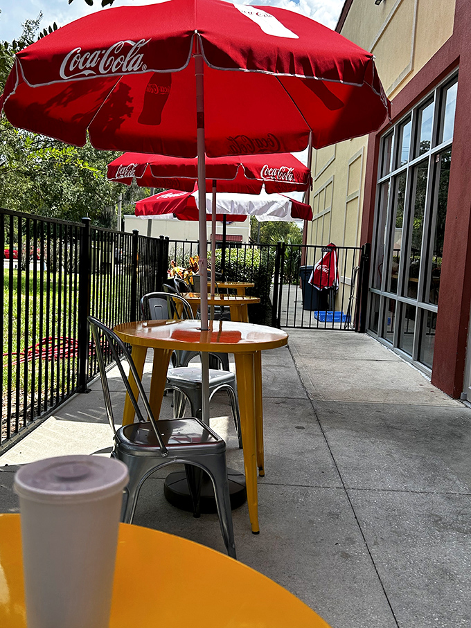 Outdoor seating under Coca-Cola umbrellas&mdash;because barbecue tastes even better with a side of Florida sunshine.